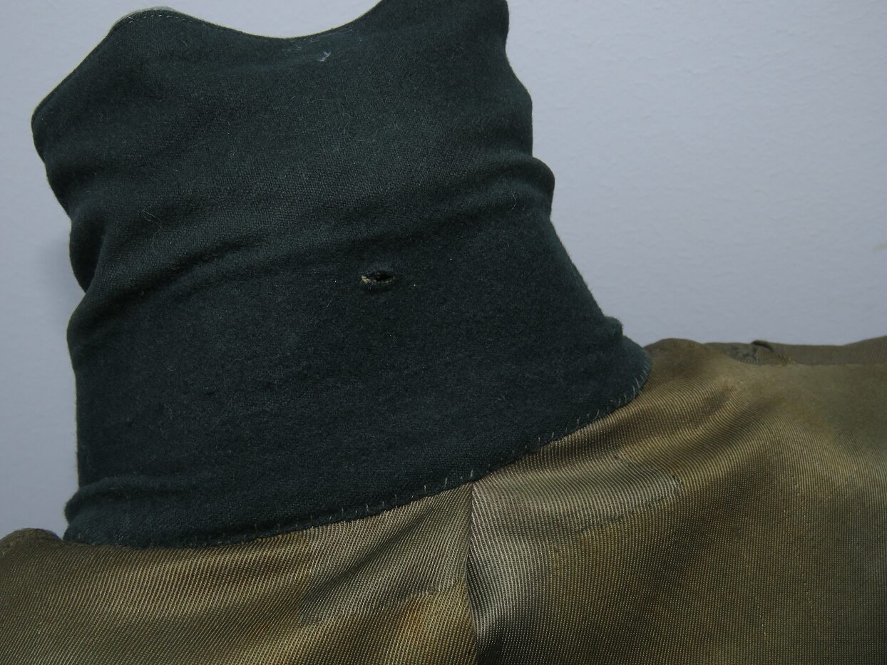 German Wehrmacht officer's tunic with a dark green collar and blue piping