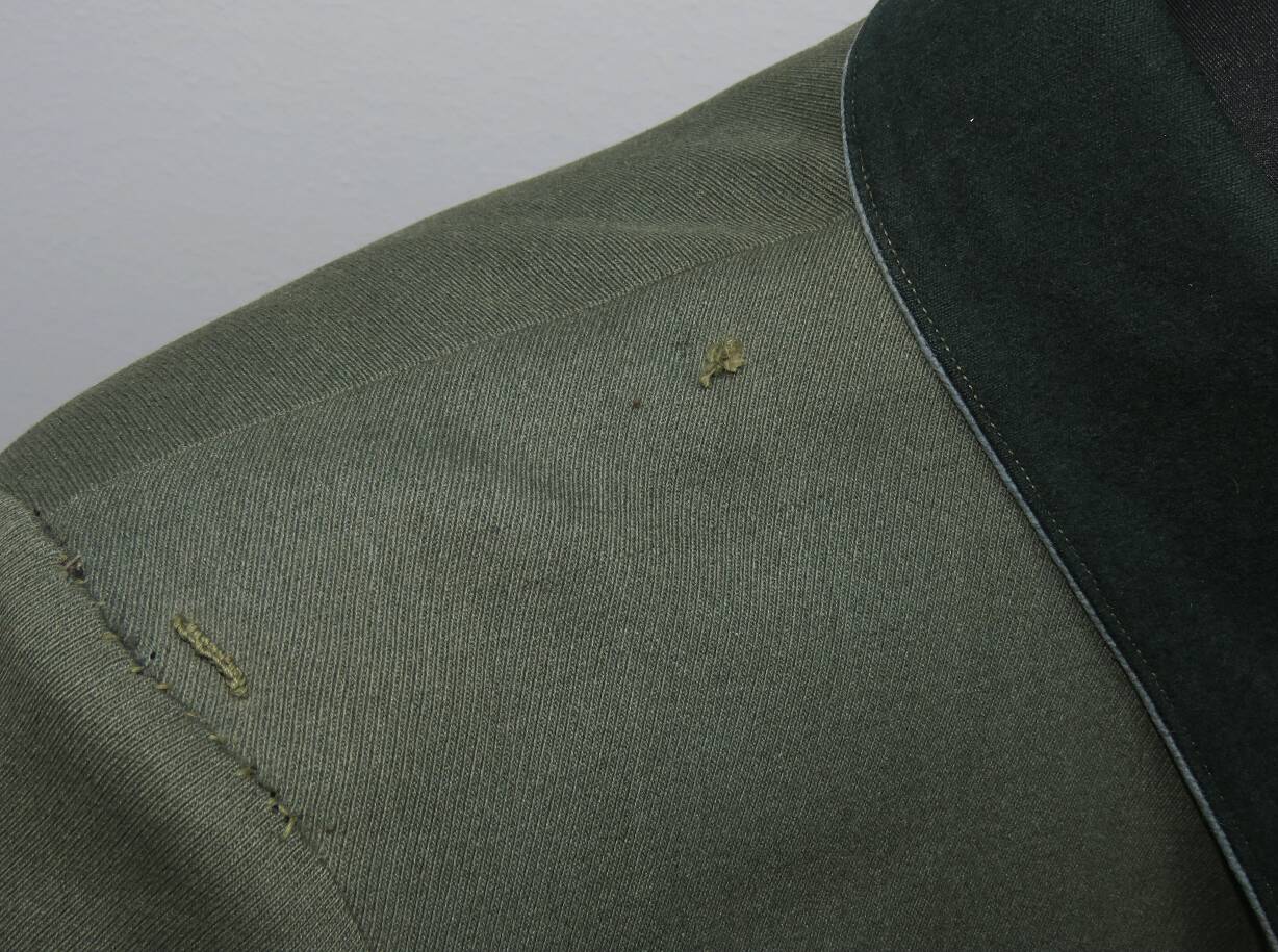 German Wehrmacht officer's tunic with a dark green collar and blue piping