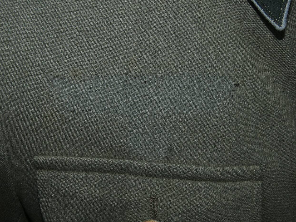 German Wehrmacht officer's tunic with a dark green collar and blue piping