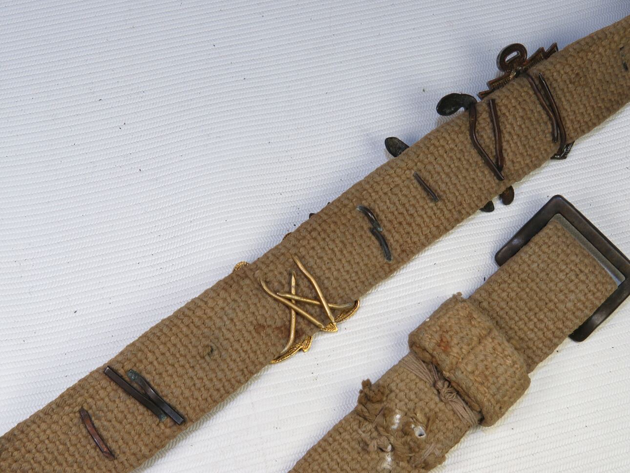 Canvas belt with German insignia, pins and ciphers