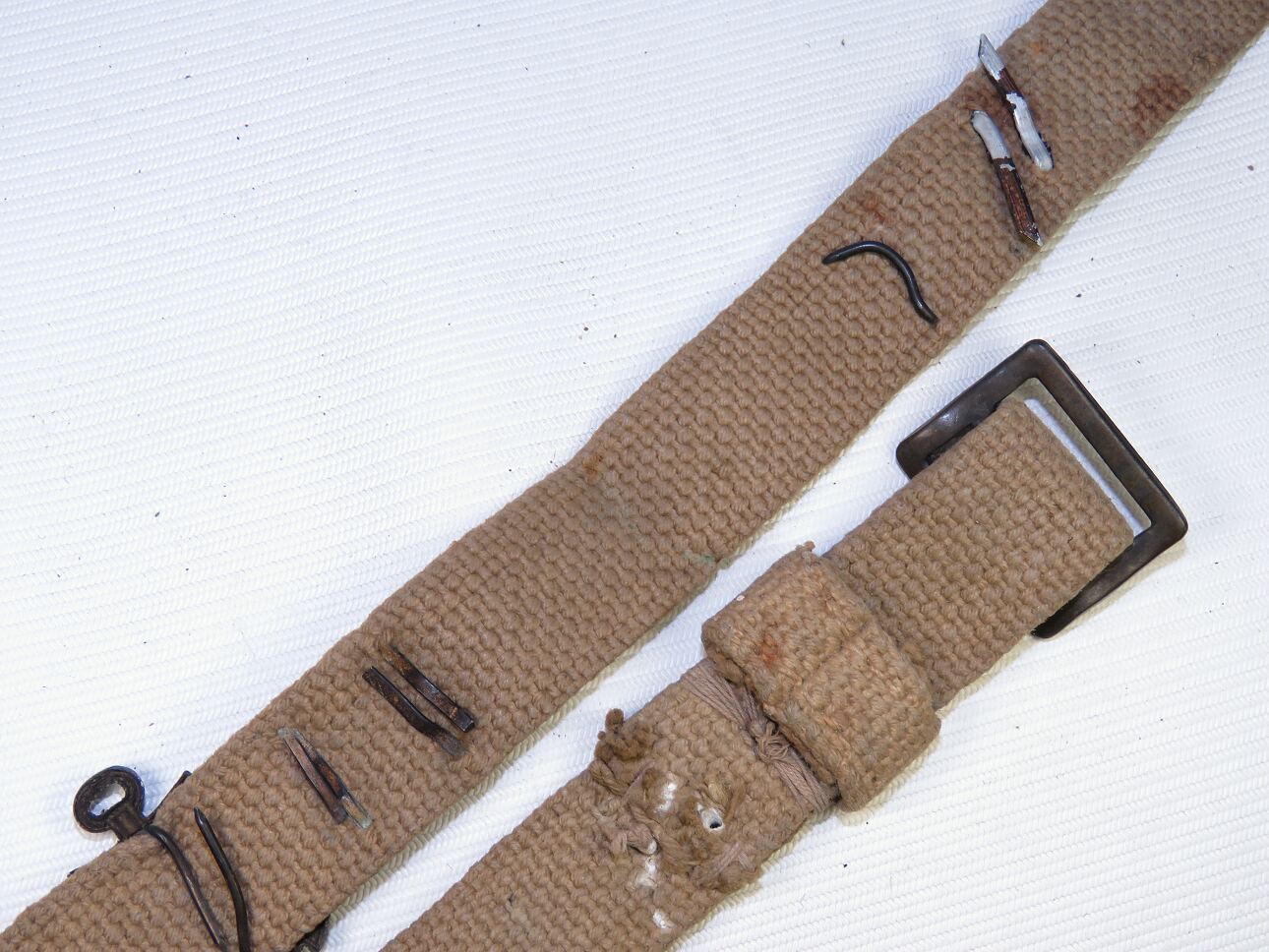 Canvas belt with German insignia, pins and ciphers