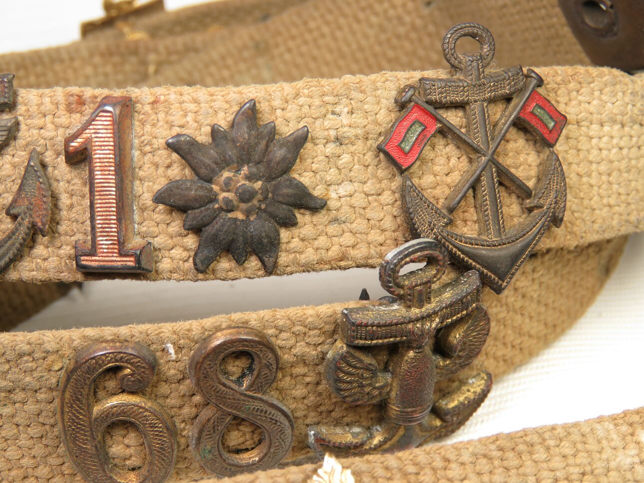 Canvas belt with German insignia, pins and ciphers
